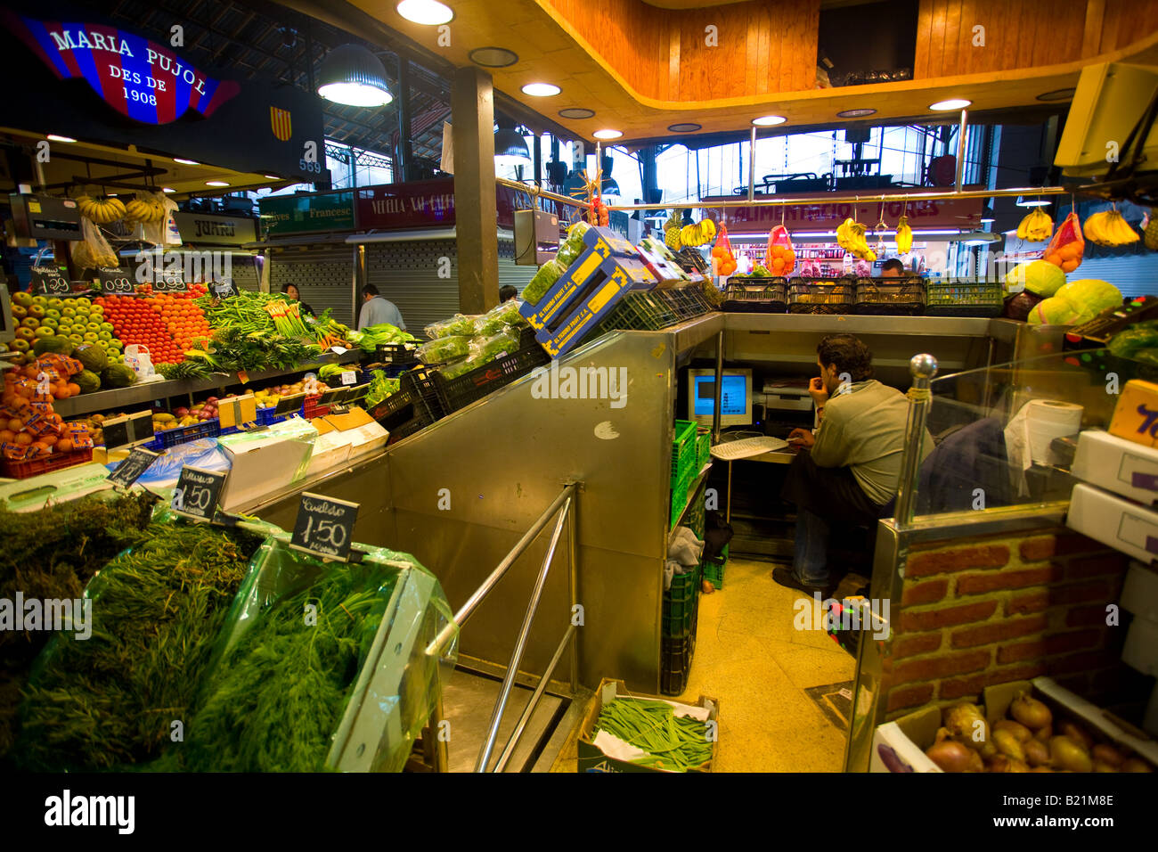 A market trader sits behind his stall Stock Photo - Alamy