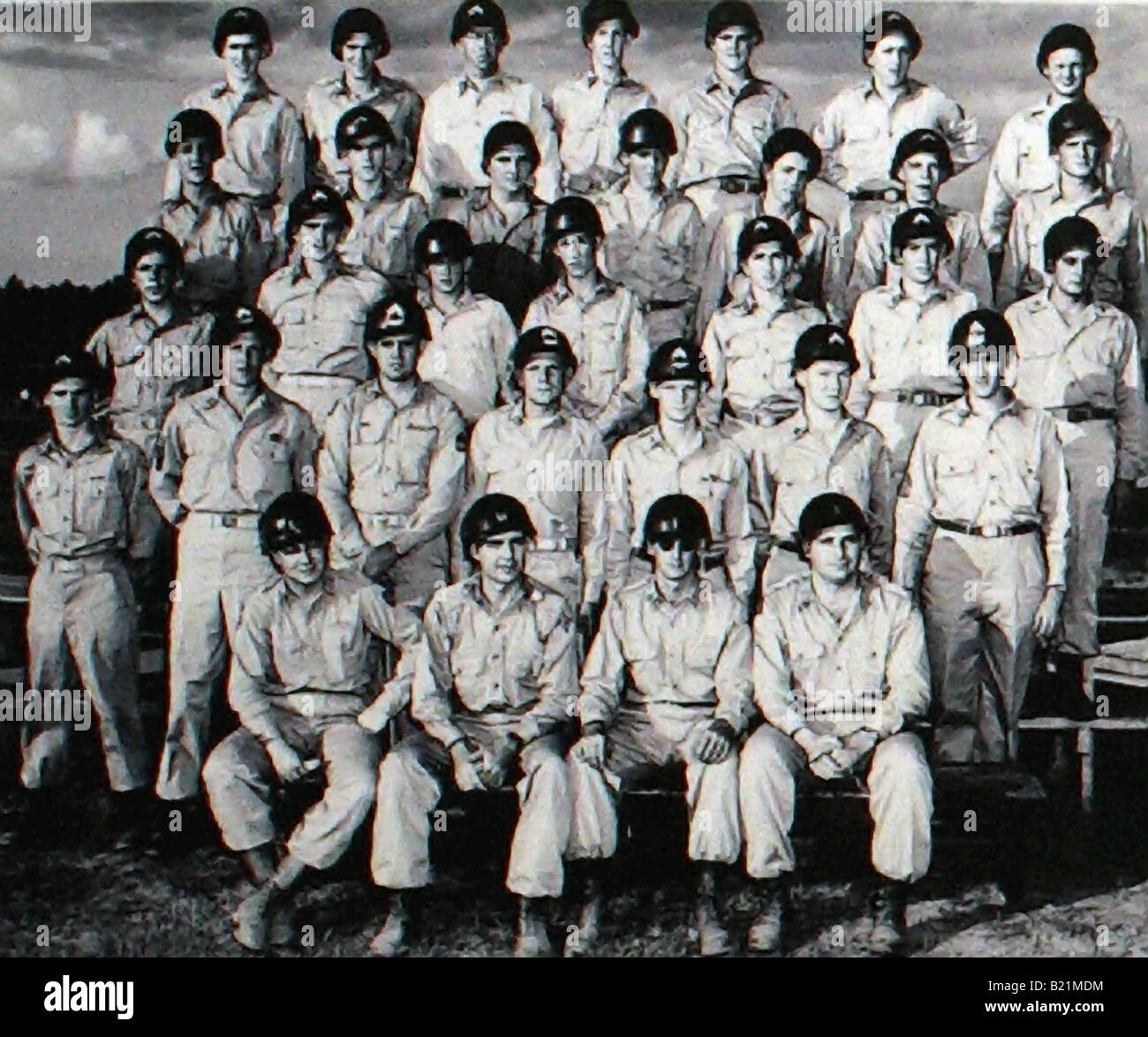 An old photograph of men and women soldiers lined up and in the army ...