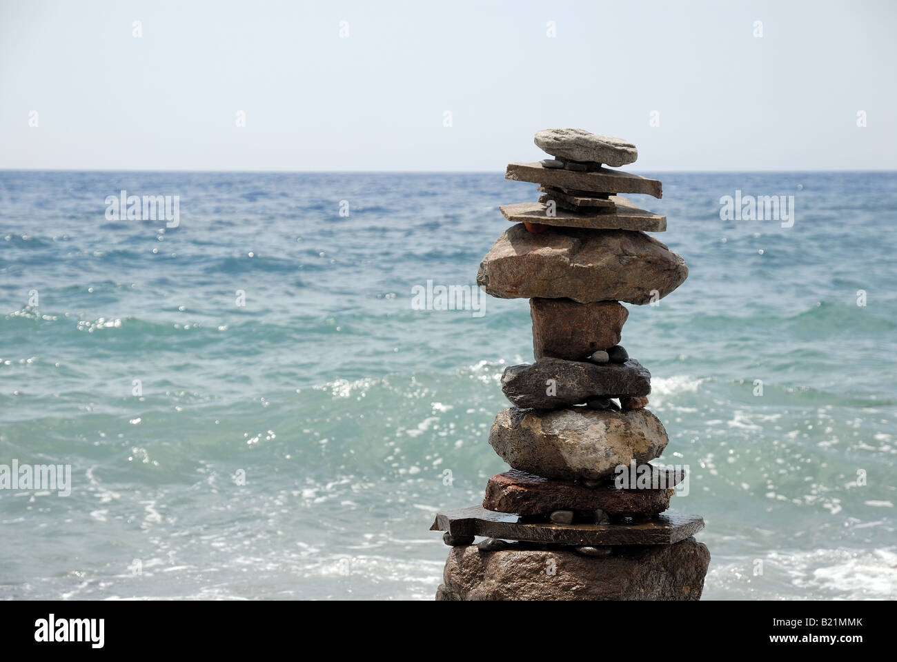 Stone pyramid on the beach in Greece Stock Photo - Alamy