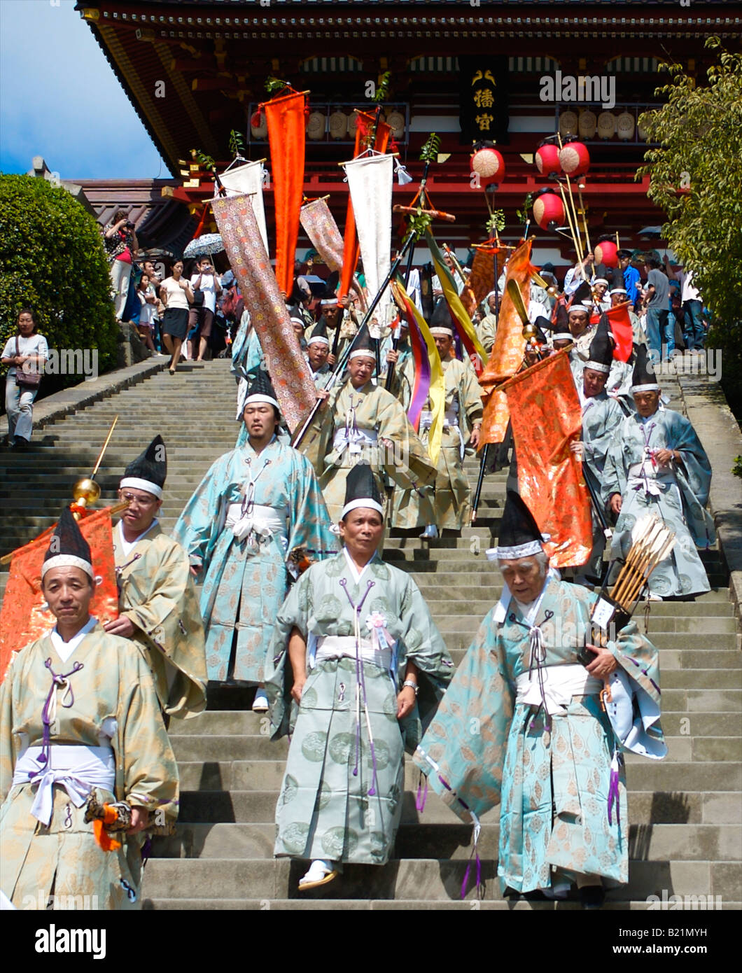 Participants wearing traditional costumes descending the stairs of ...