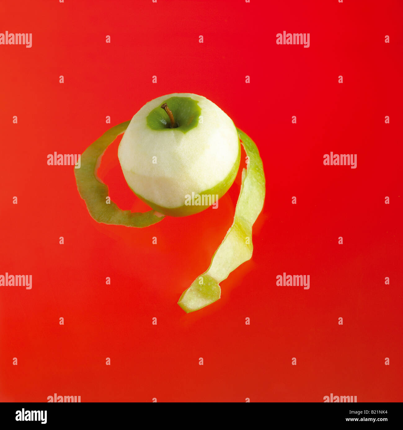 apple peeled on a red background Stock Photo - Alamy