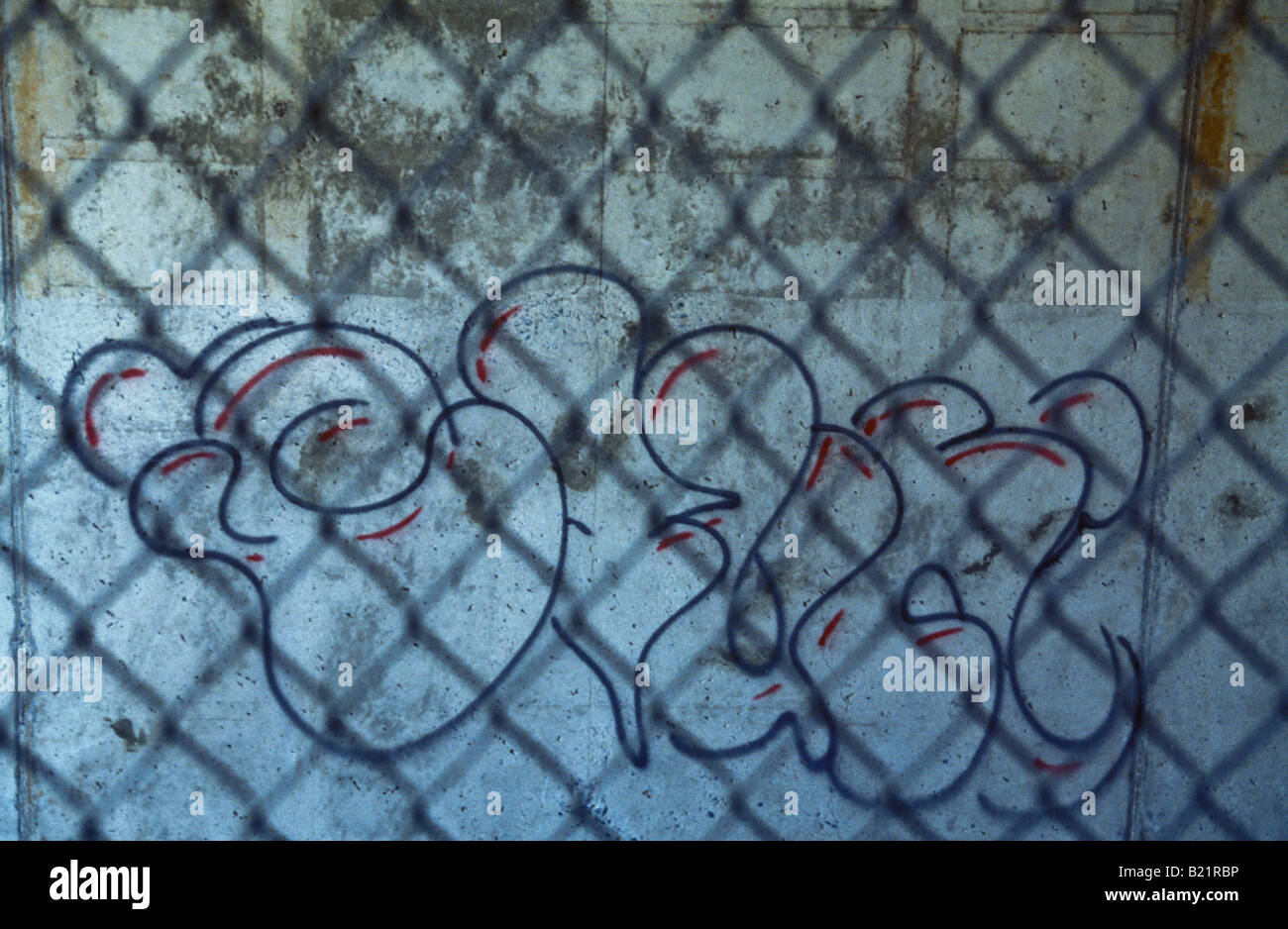 Urban wall graffiti and wire fence Stock Photo - Alamy