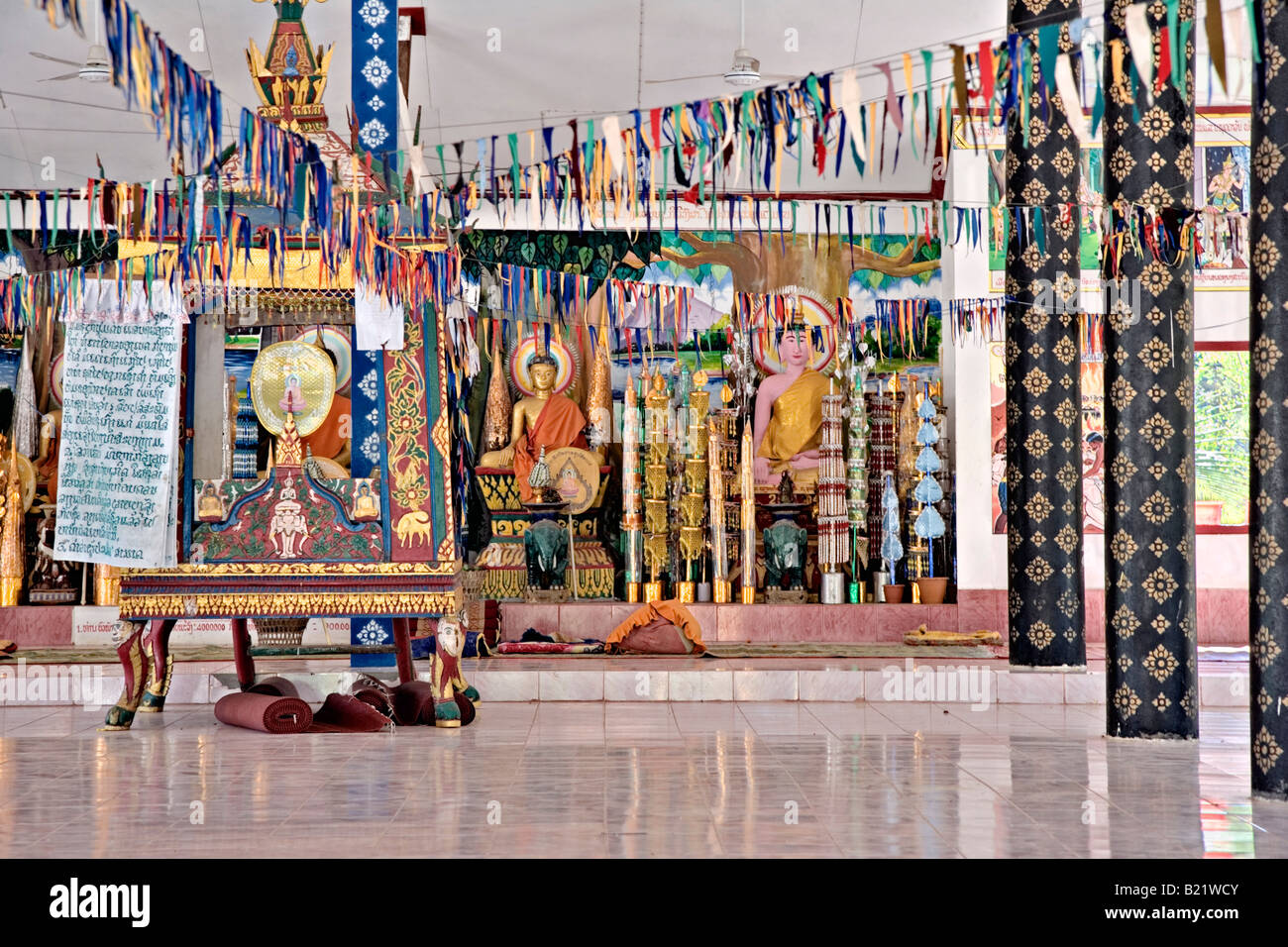 Buddhist temple interior showing busy religious decor, southern Laos ...