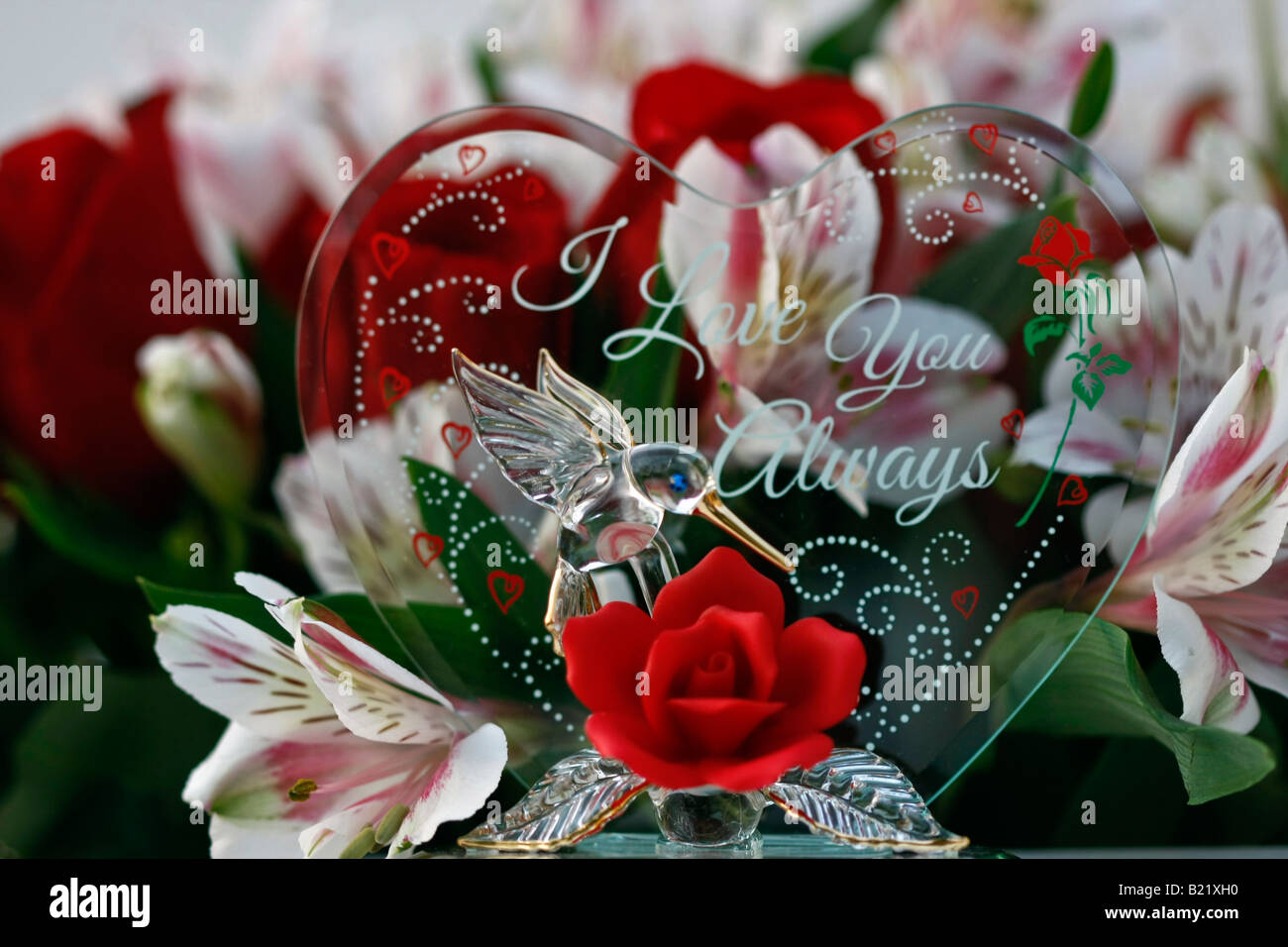 Bouquet of red roses with heart of glass for Valentines Day blurry ...