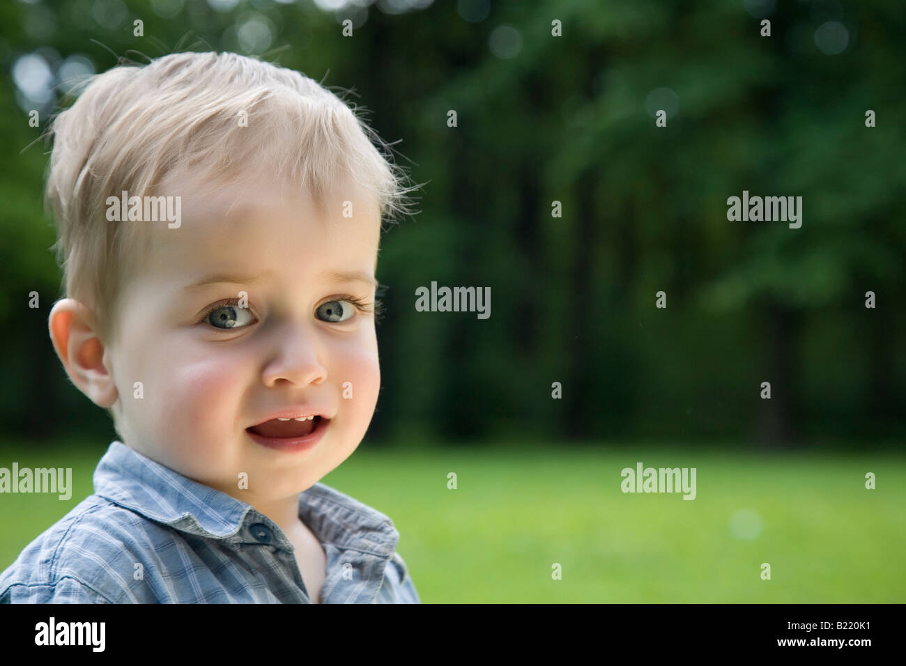 Serious Little Boy On The Nature Background Stock Photo - Alamy