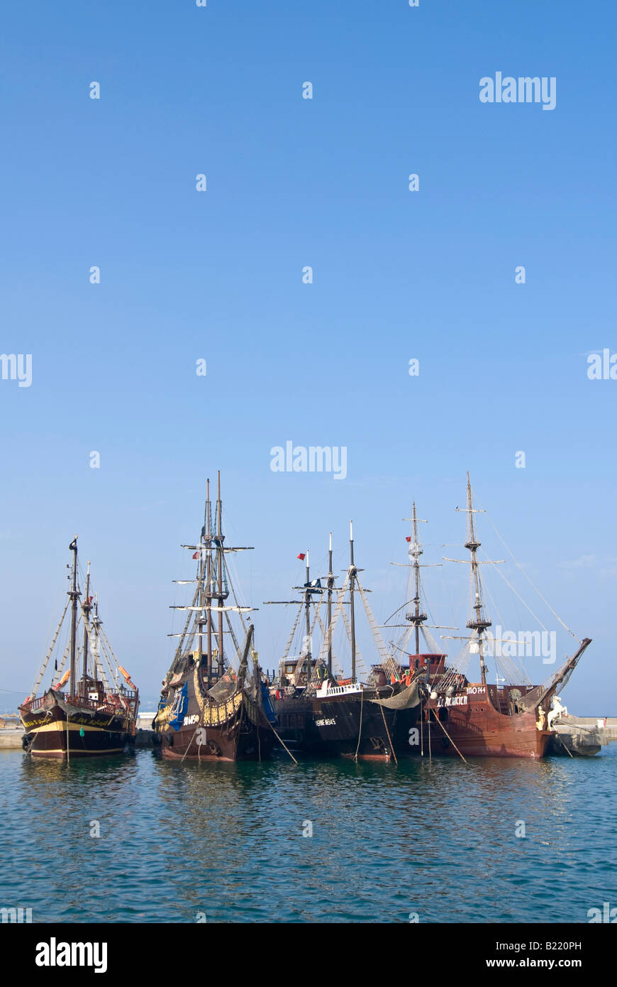 Vertical view of four galleon style pirate ships moored alongside each ...