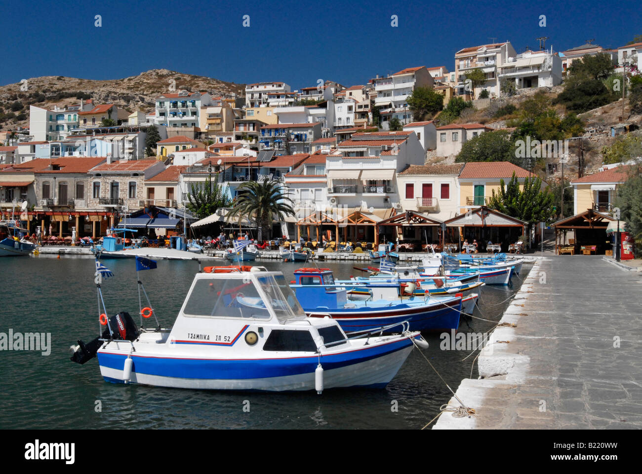 Greek harbour with boats and taverns Stock Photo - Alamy