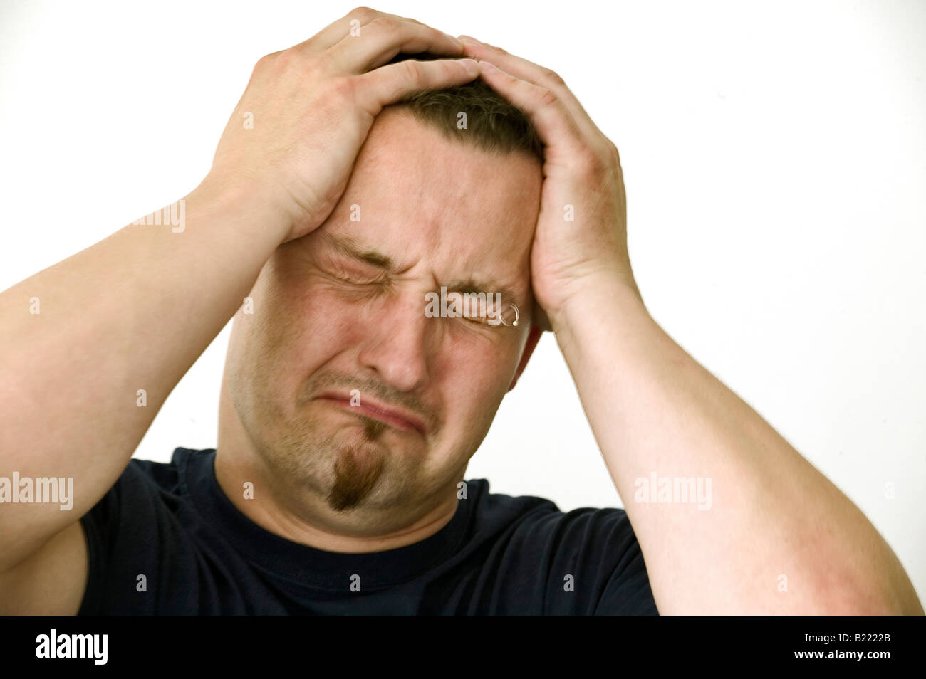 man helpless hands on head grimace Stock Photo - Alamy