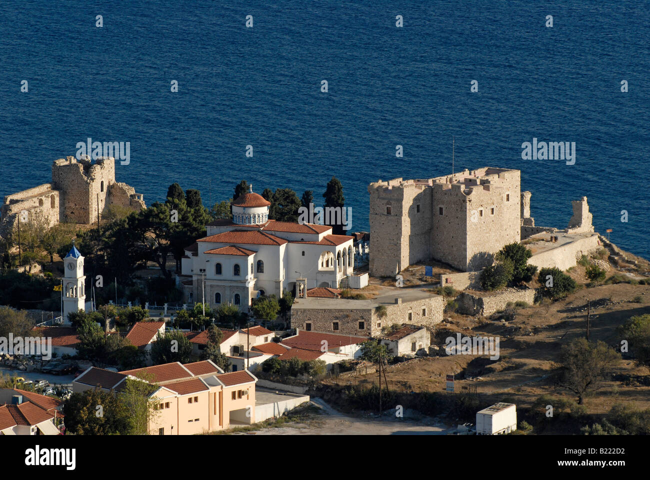 Greek castle, church and houses on a hill above the blue sea Stock ...