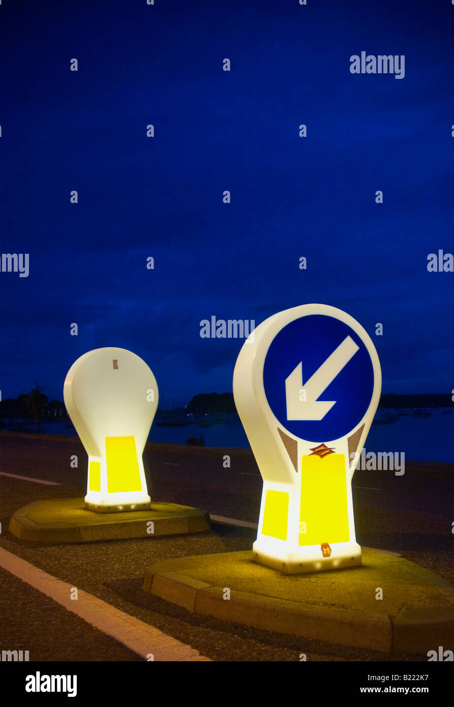 Illuminated keep to the left arrow road sign Stock Photo - Alamy