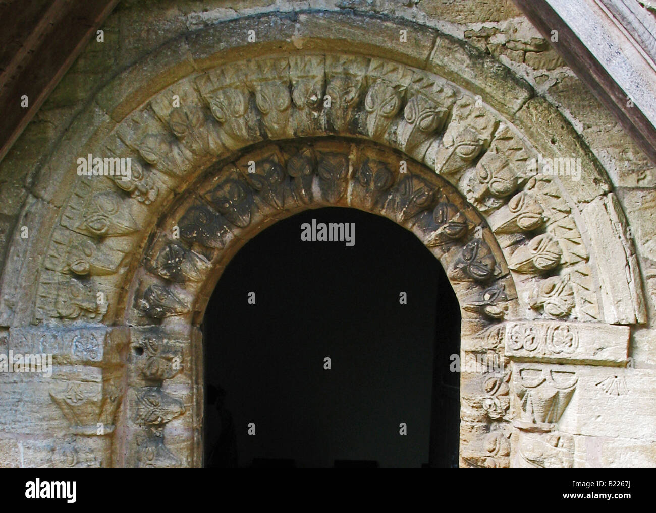 Beakhead carvings round door of Windrush church Stock Photo - Alamy