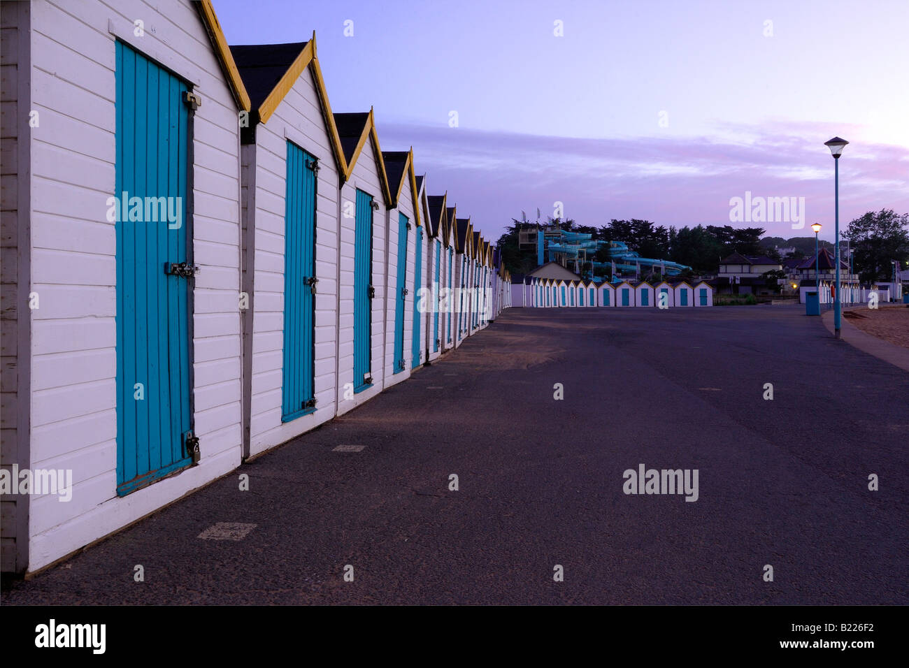 Blue and white beach huts just before dawn on the promenadxe at ...