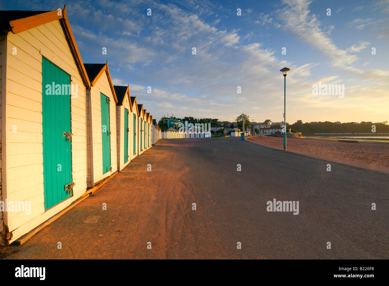 Blue and white beach huts in lovely dawn light on the promenade at ...