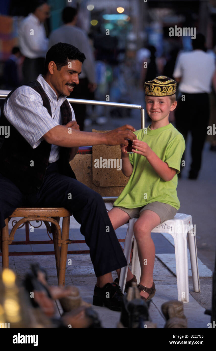 European boy trying Egytian hood on Bazar Downtown Hurghada Egypt Stock ...