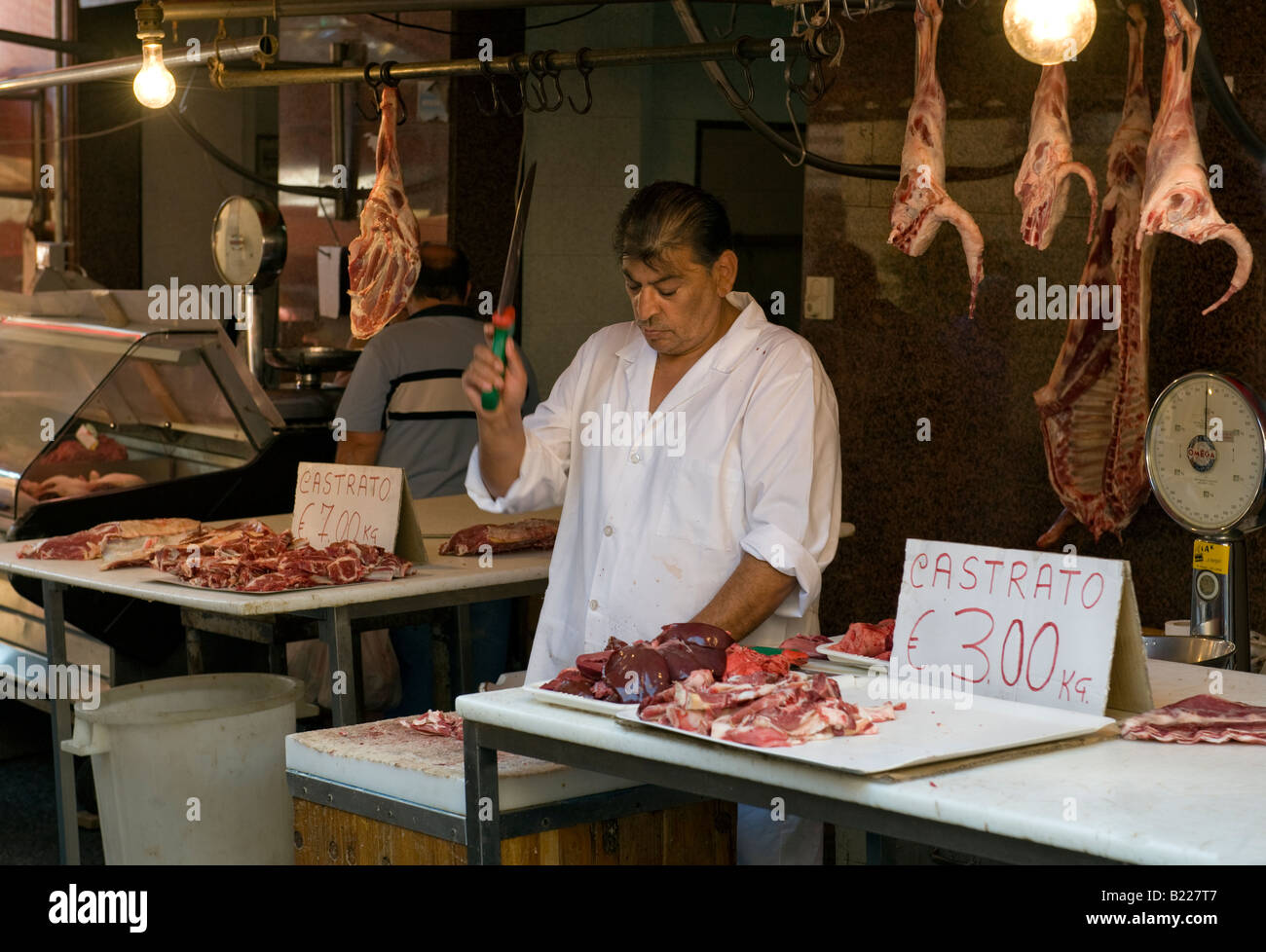 Butcher preparing meat for sale at market Stock Photo - Alamy