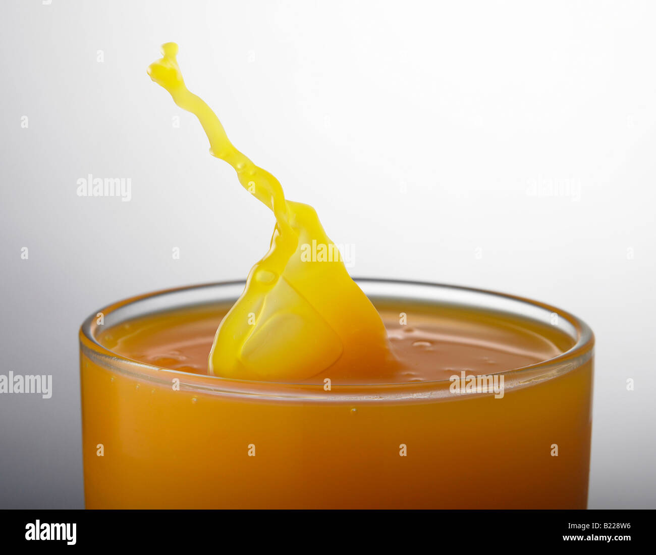 splash from glass of orange juice Stock Photo - Alamy