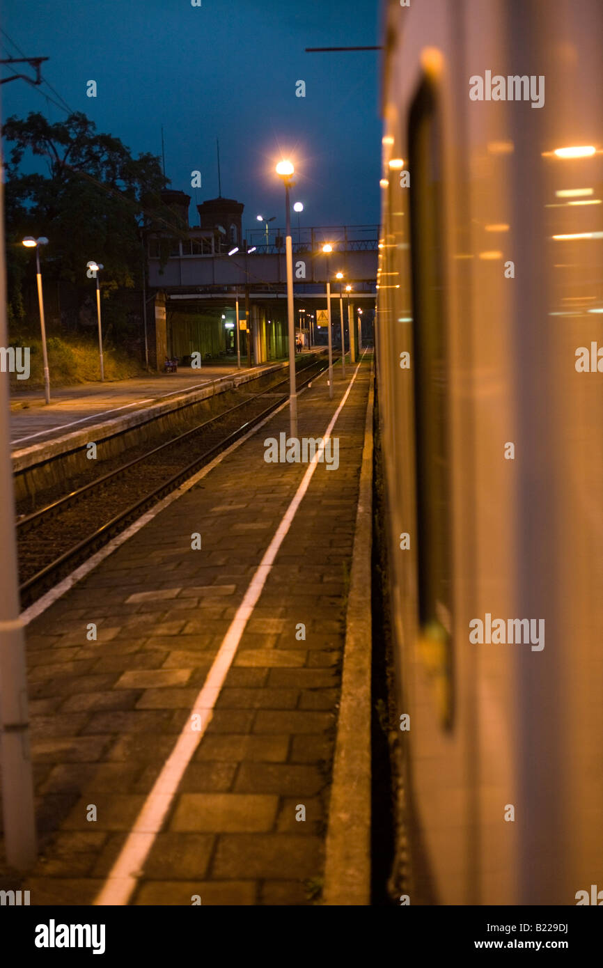 Side of train, platform and tracks at late evening Stock Photo - Alamy