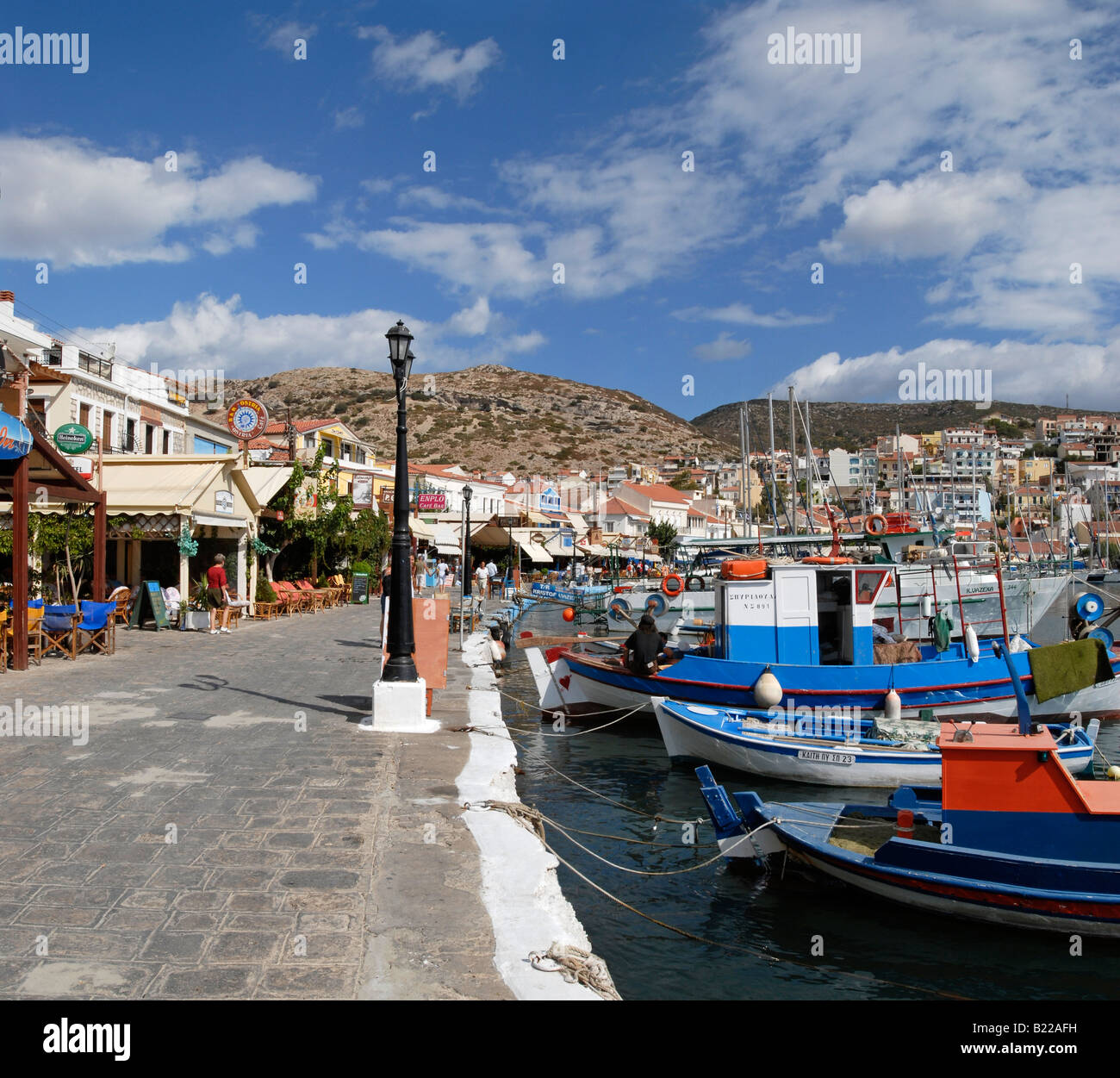 Greek harbour with boats and taverns Stock Photo - Alamy