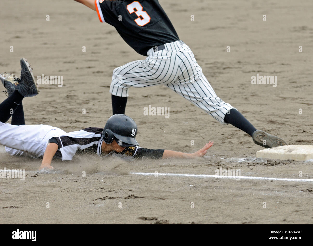 Reaching for the base Japanese baseball Sendai Japan Stock Photo - Alamy