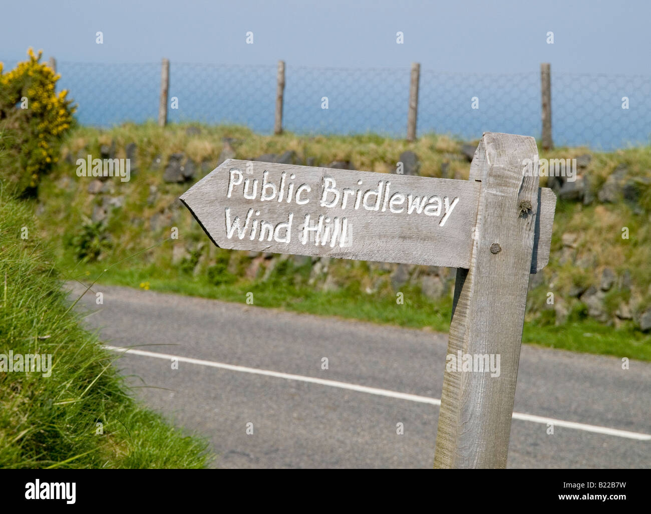 A wooden marker by the road pointing towards Wind Hill in Exmoor ...