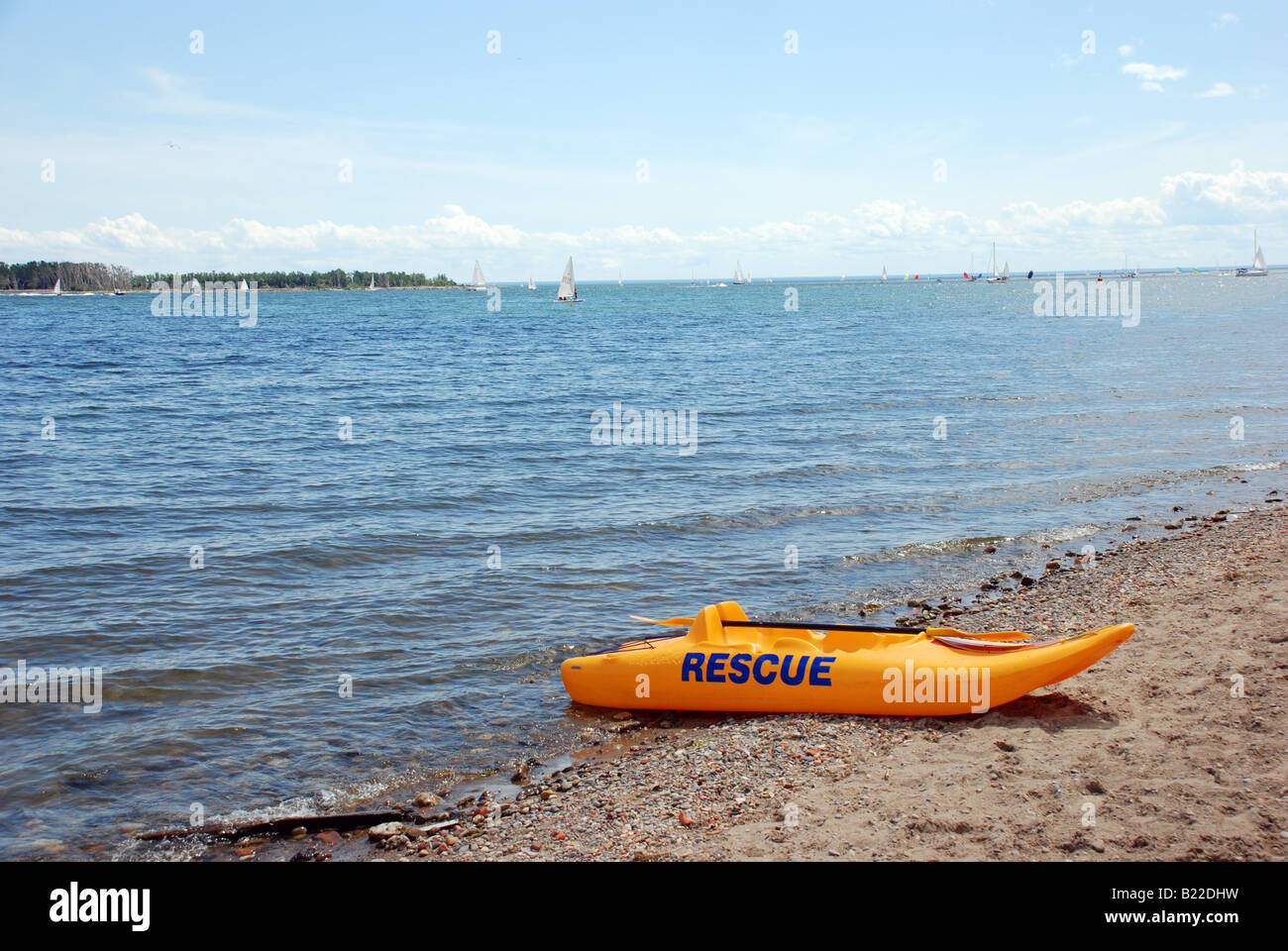 Yellow rescue boat on the lake beach Stock Photo - Alamy