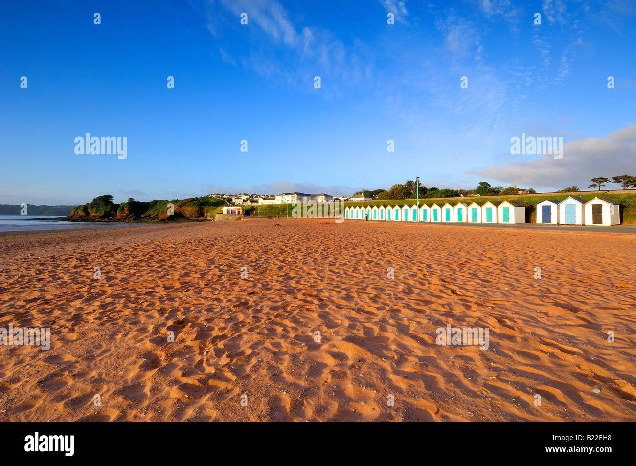 Colourful beach huts in lovely dawn light on the promenade at ...
