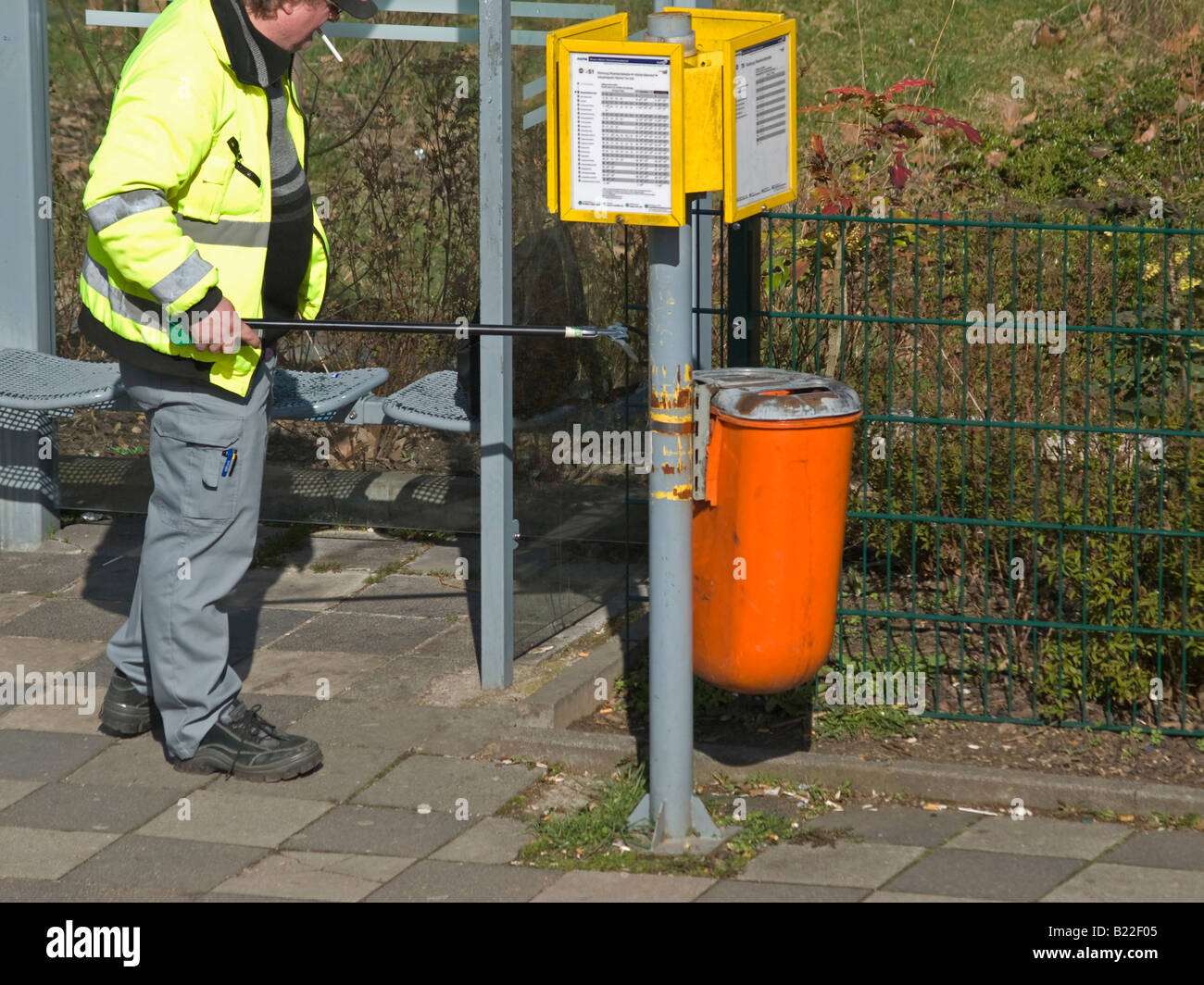 man of the city is picking up trash at the bus station in Frankfurt am ...