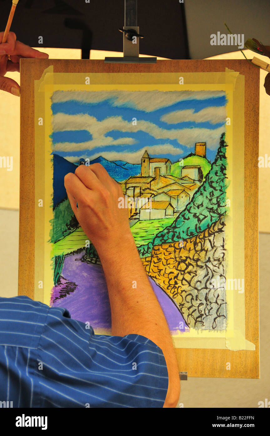 Painter inserting blue shadows onto mountains at an arts festival Stock ...