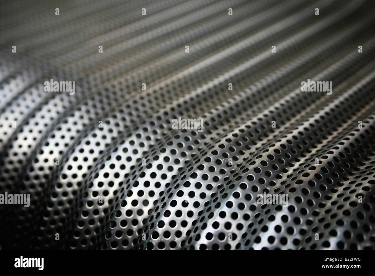Metalic chair bench with loads of holes Stock Photo - Alamy