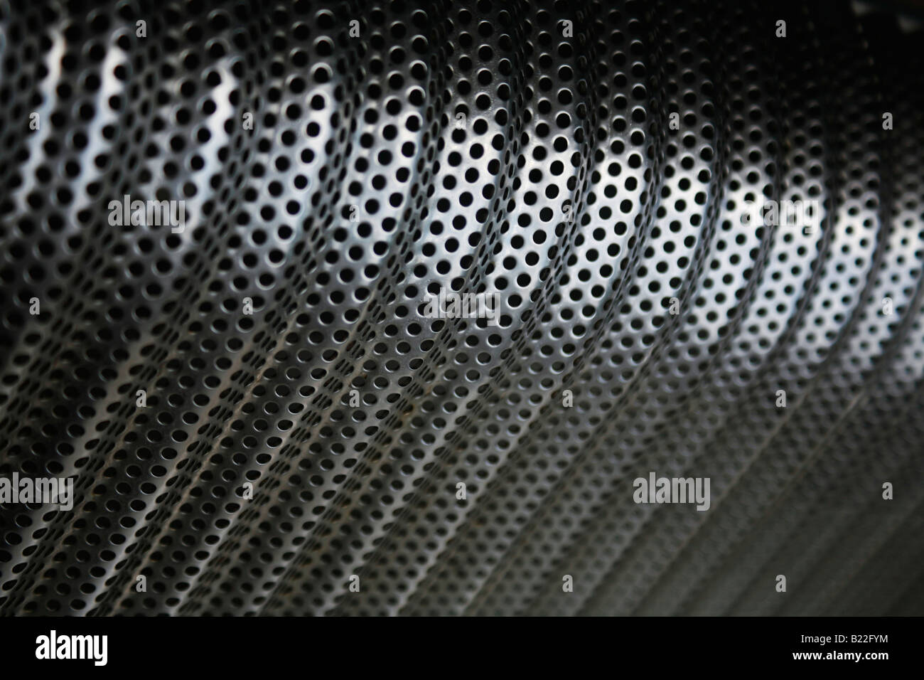 Metalic chair bench with loads of holes Stock Photo - Alamy