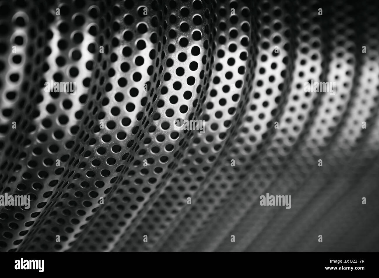 Metalic chair bench with loads of holes Stock Photo - Alamy