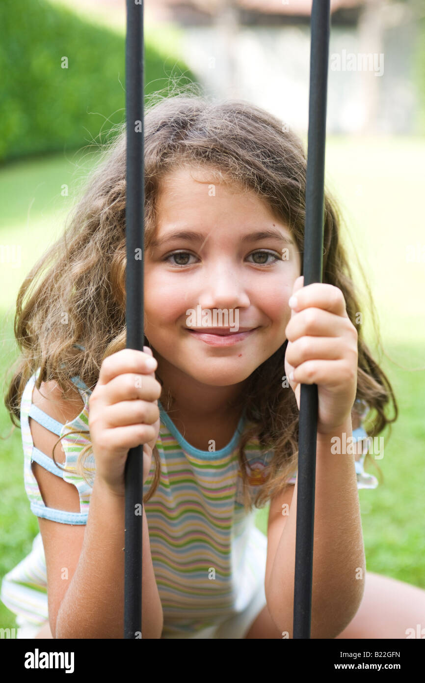 Pretty child portrait behind bars Stock Photo - Alamy
