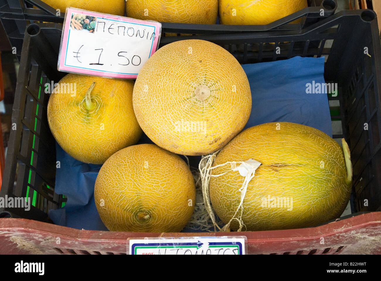 melons for sale with price tag on a market in Greece Stock Photo - Alamy