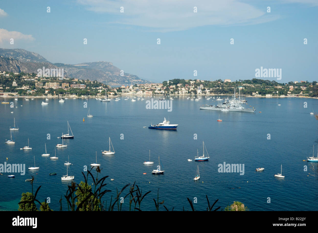 Steep Jagged Mountains fall sharply to colourful buildings set in a ...