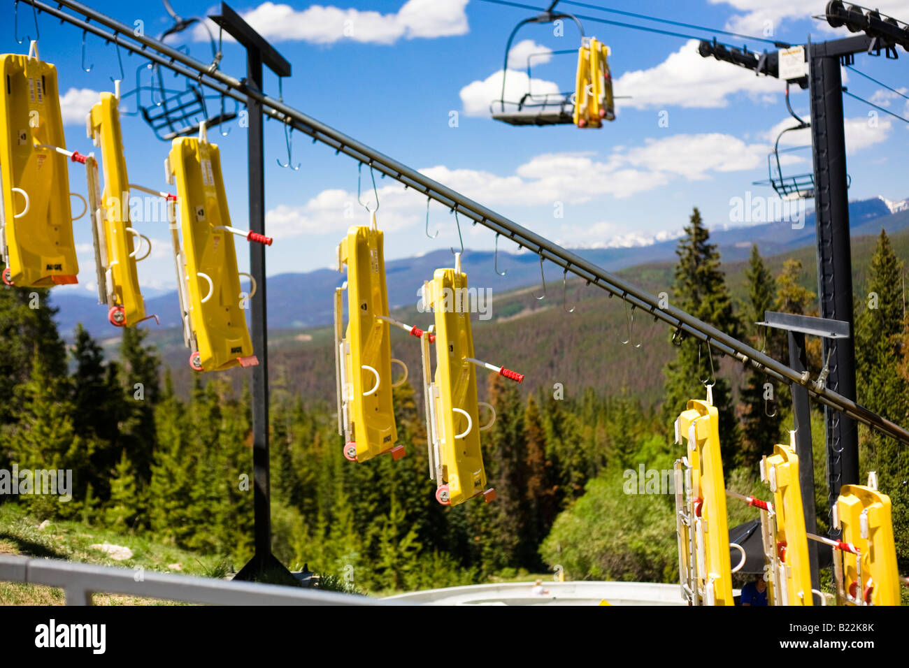 Yellow alpine sleds on ski lifts and racks being taken to sledders at ...