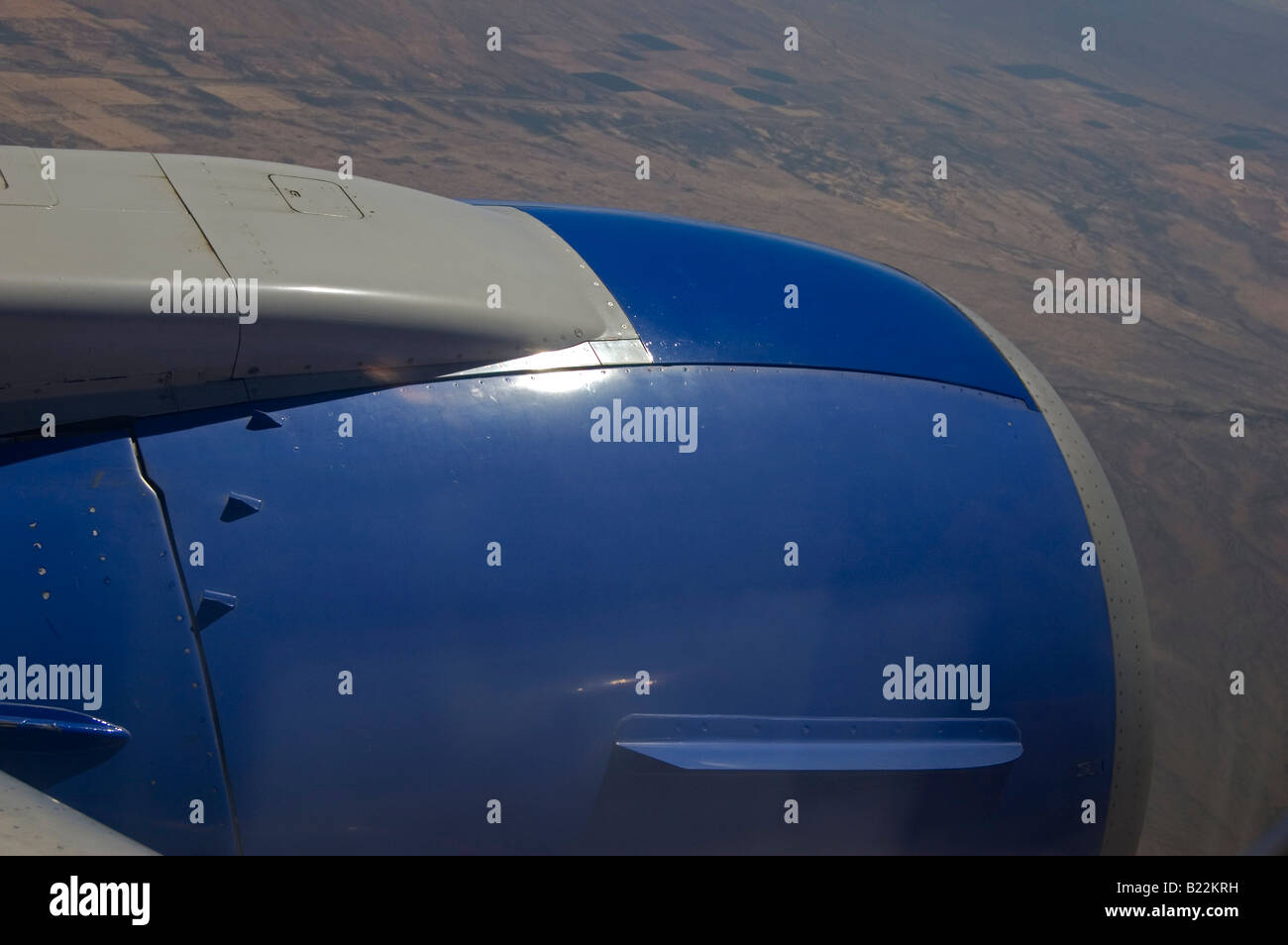 Jet engine and view of land from airplane window Stock Photo - Alamy
