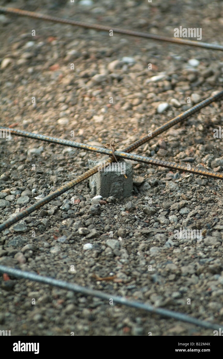 Steel Rebar rods supported by a small concrete box before concrete ...