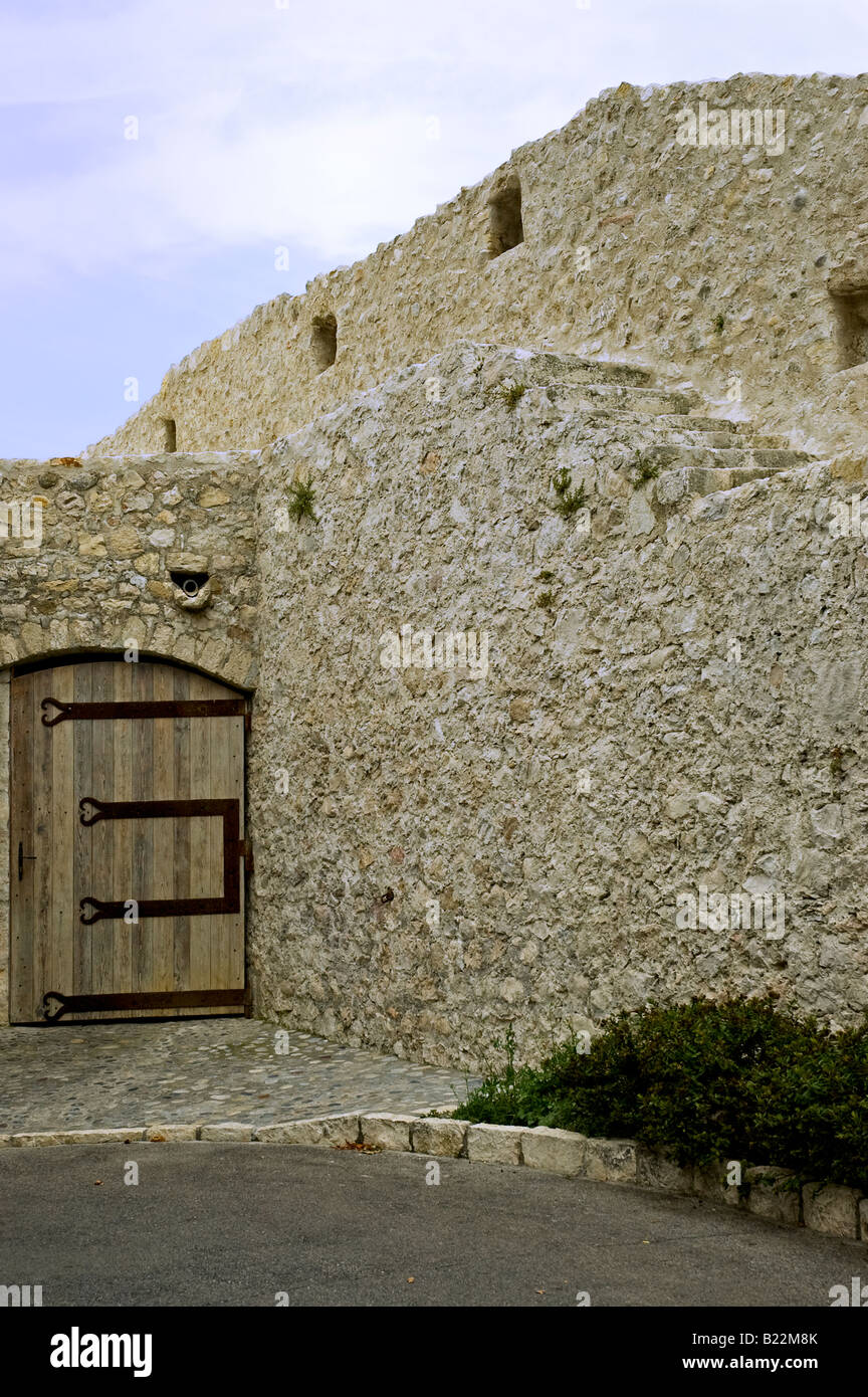 Stone Steps lead up to the Ramparts above a strong Wooden Gate leading ...