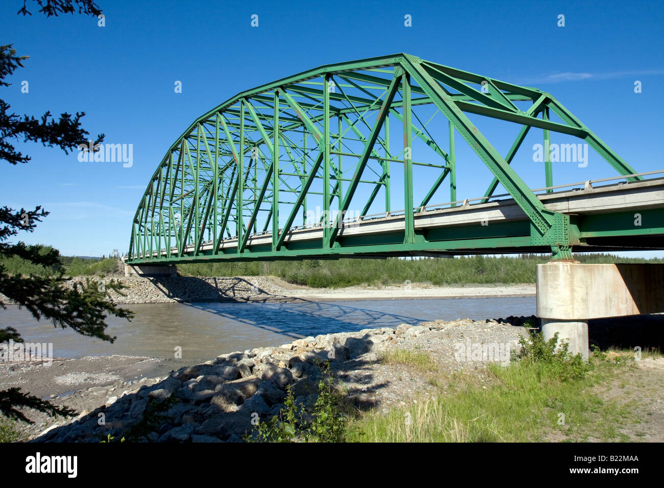 A green highway bridge crossing one of the many rivers in Alaska Stock ...