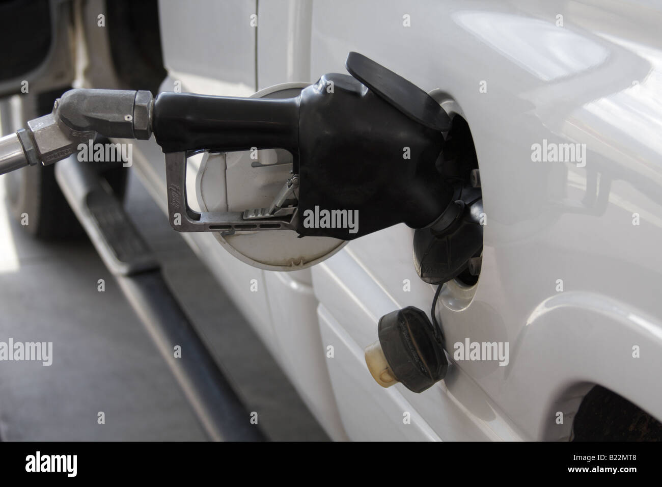 Gasoline pump handle inserted into filler of a truck Stock Photo - Alamy