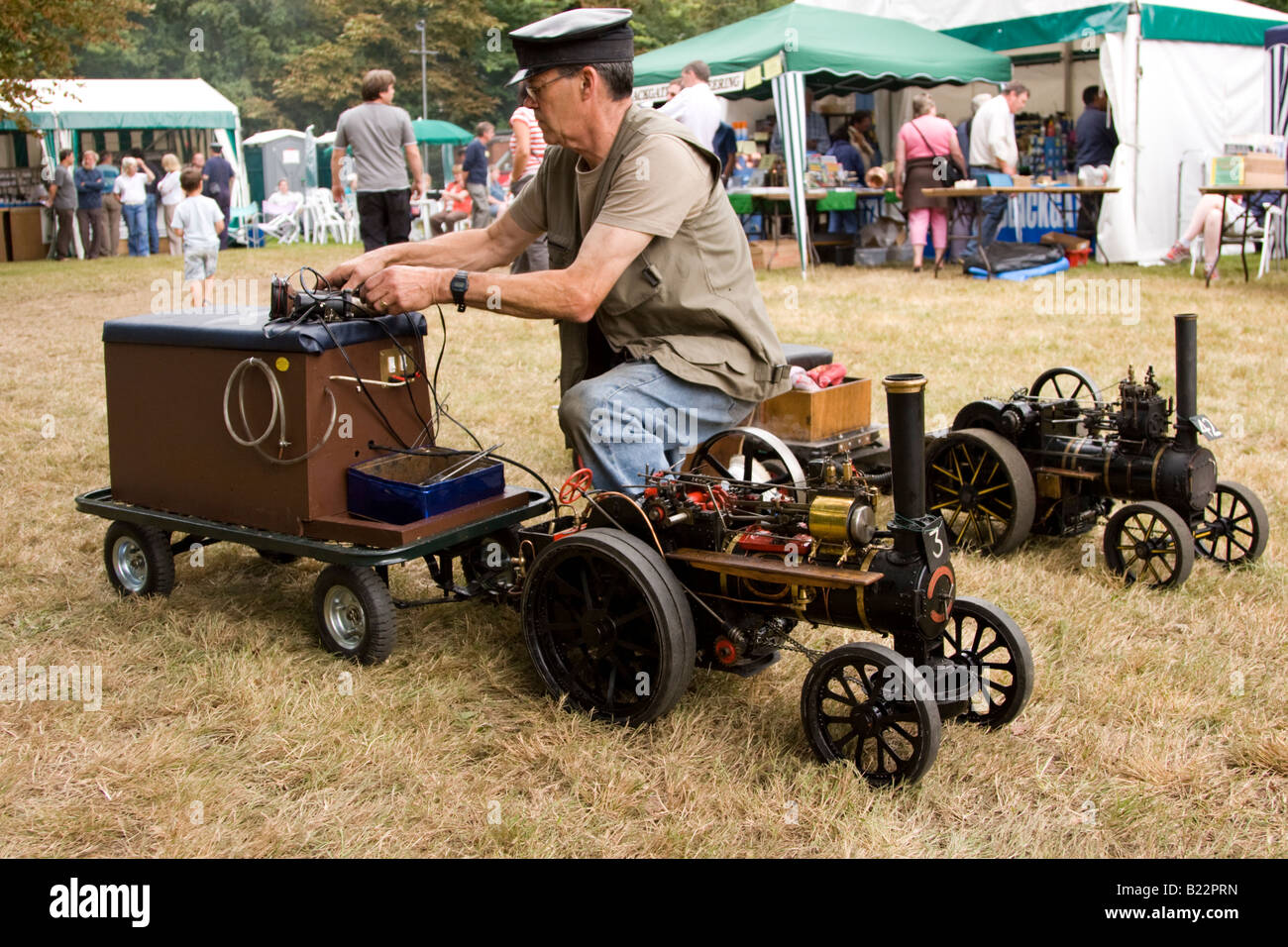 Driver attending to two small model steam traction engines Stock Photo ...