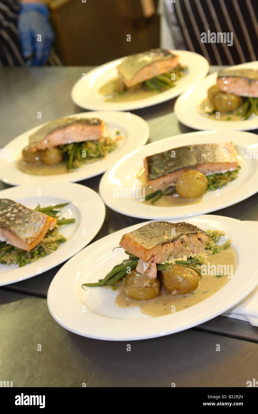 Hotel restaurant kitchen catering salmon fish dinner plated up ready to ...