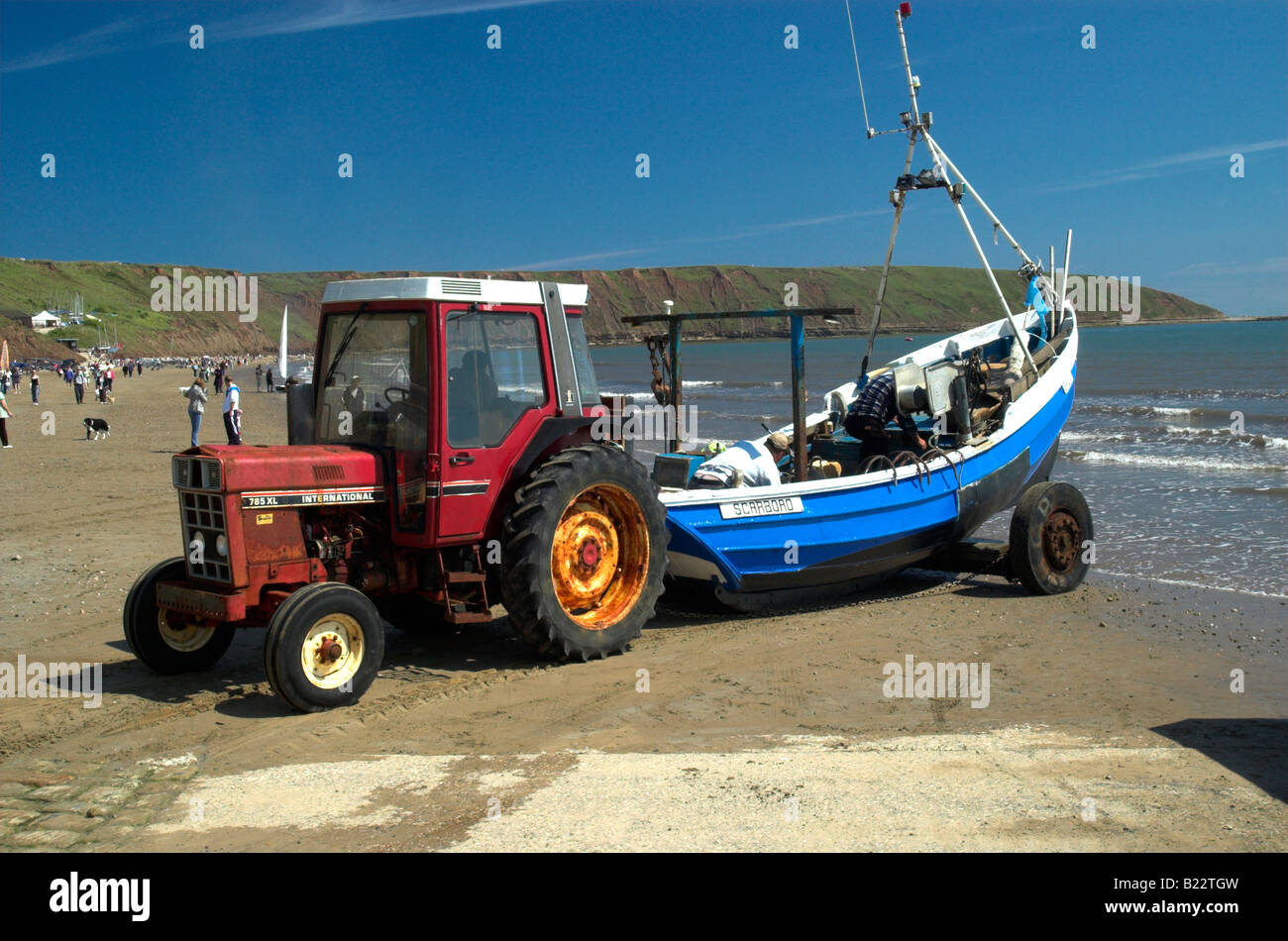Tractor Lauching Coble boat to sea at the start of a fishing trip Stock ...
