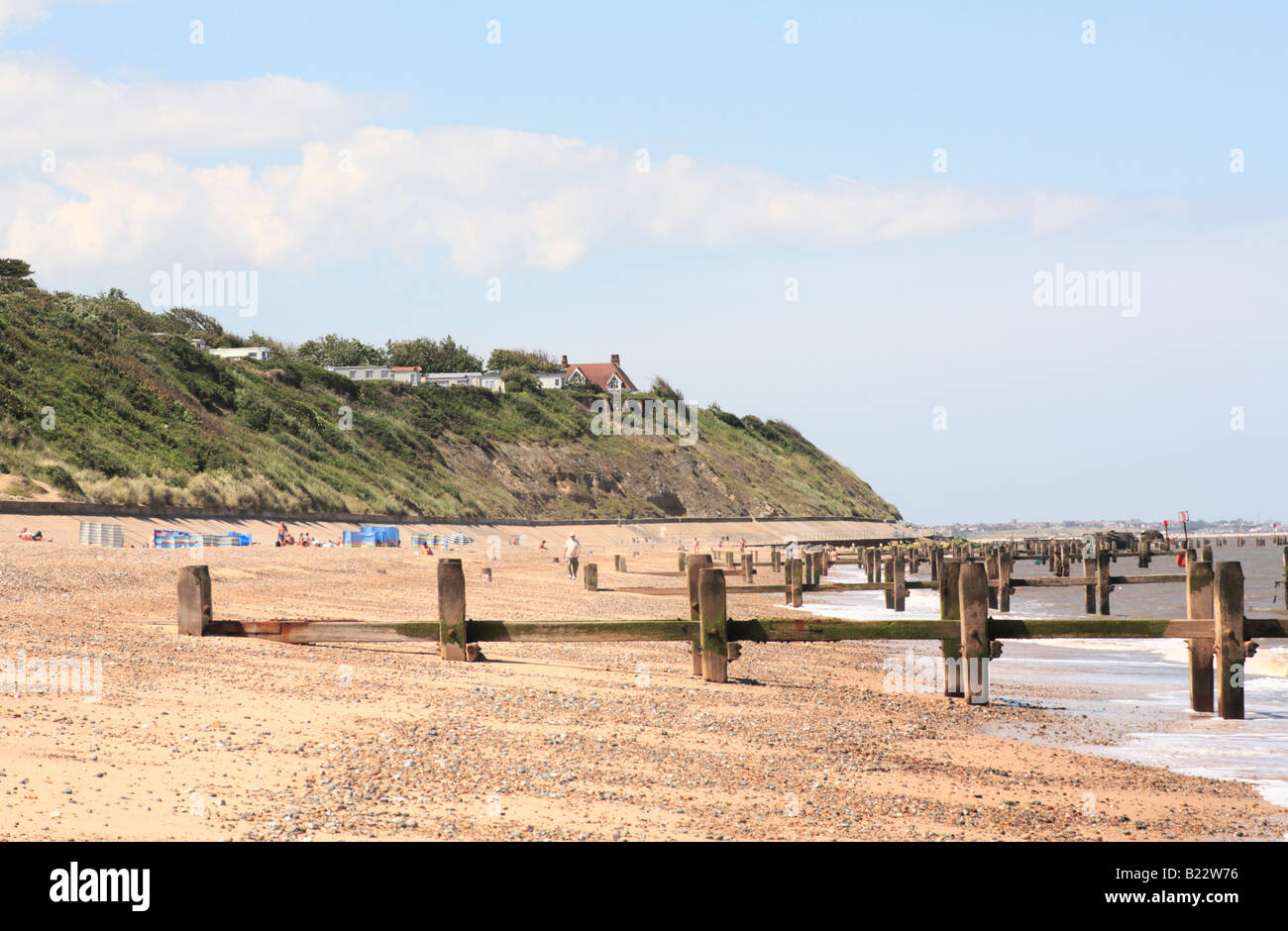 beach groynes cliffs and sunbathers Stock Photo - Alamy