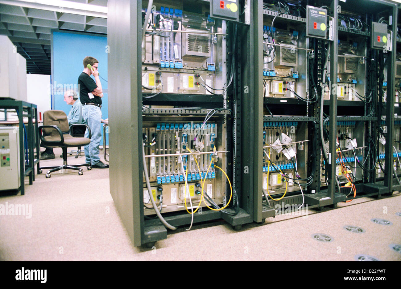 Side profile of man talking on landline phone in server room Stock ...
