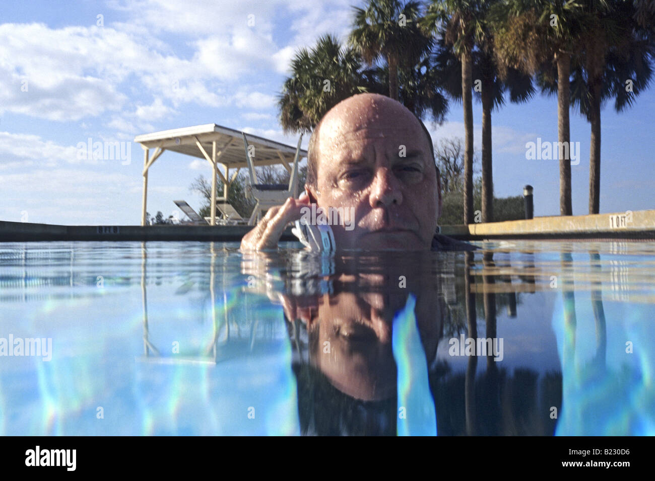 Businessman using mobile phone in swimming pool Stock Photo - Alamy