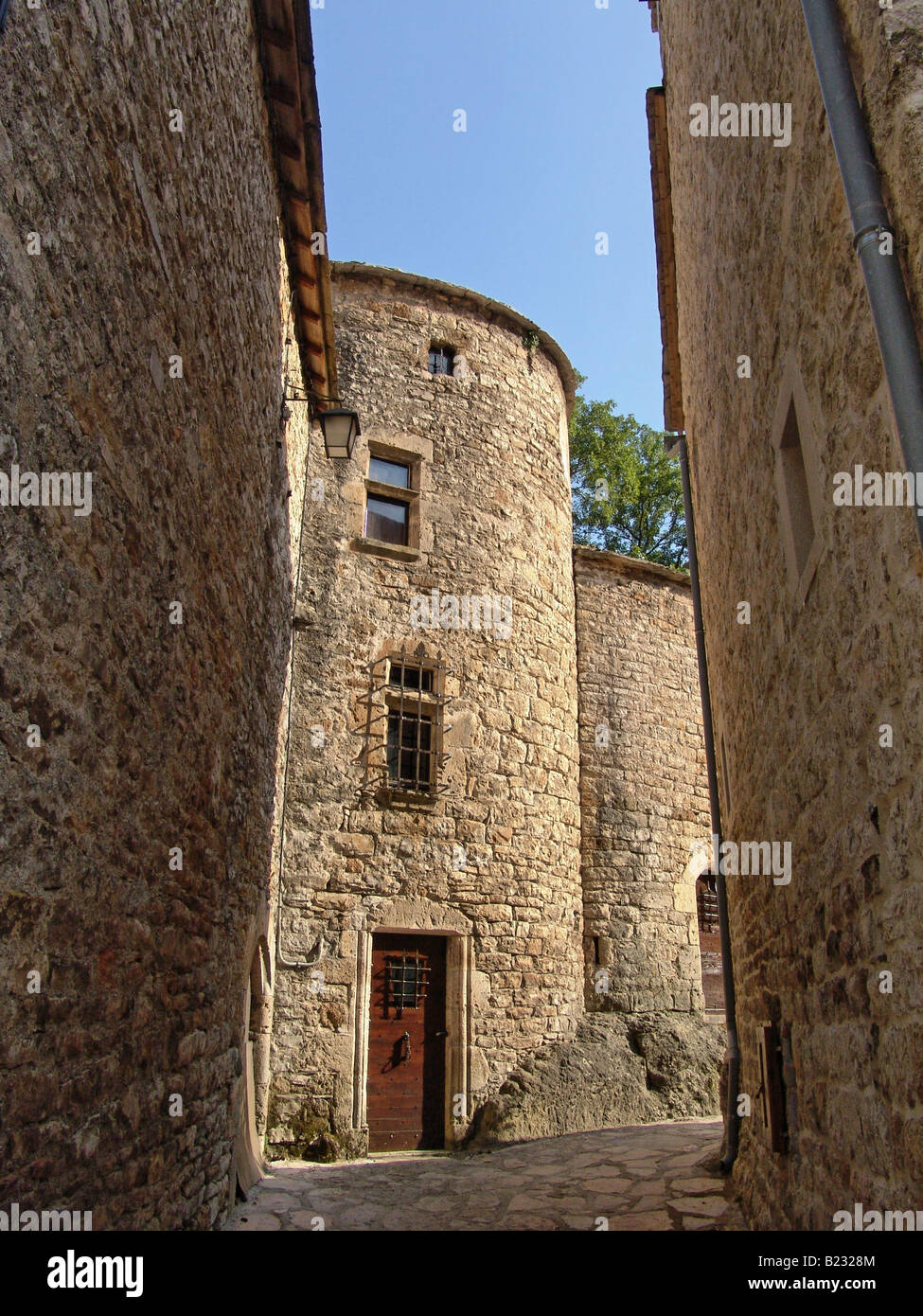 Old buildings on both sides of alley, Saint Chely du Tarn, France Stock ...