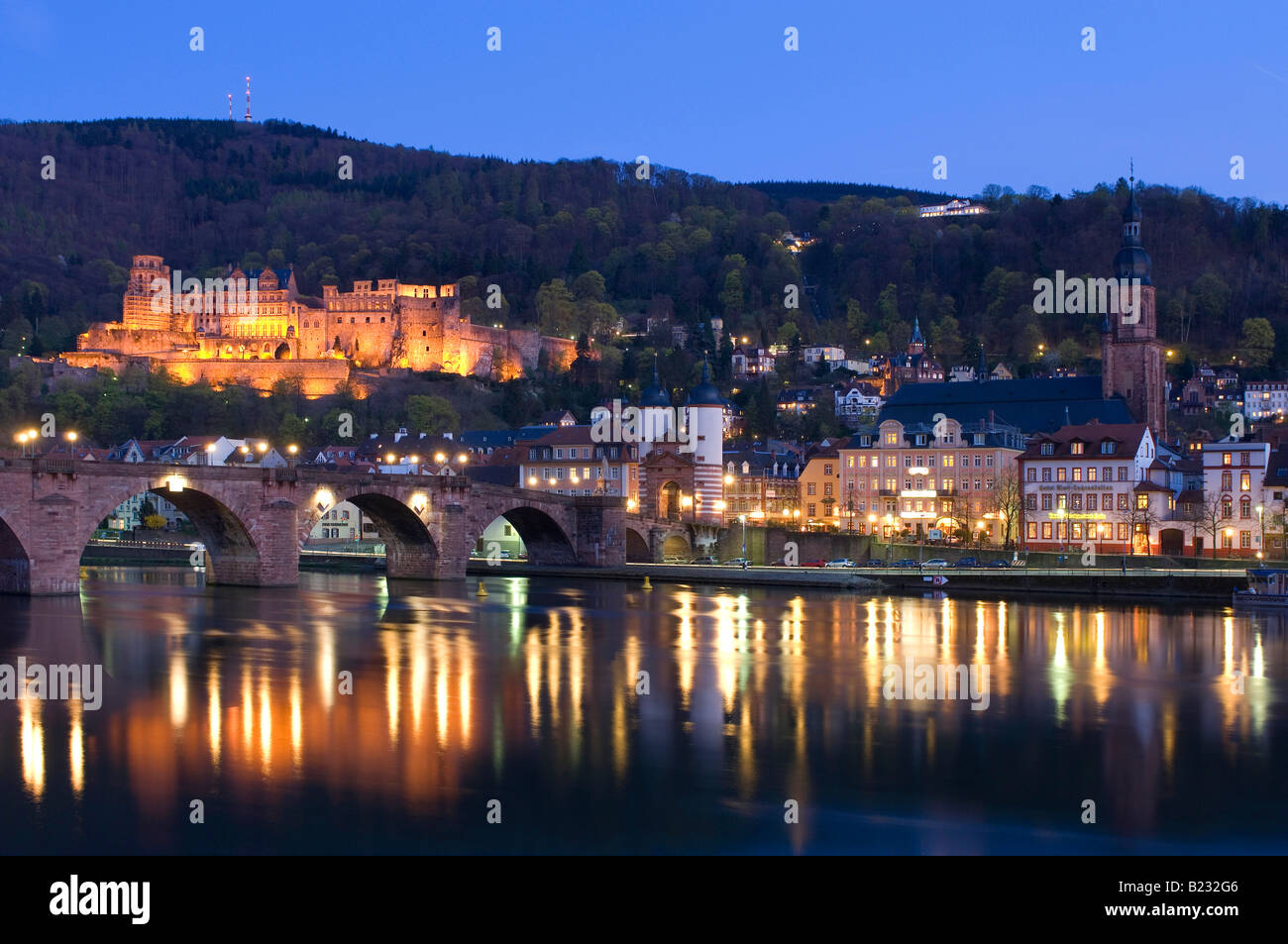 Arch bridge across river lit up at dusk, River Neckar, Germany Stock ...