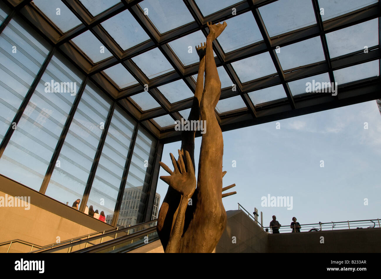 A statue of a stretched human figure standing on its head designed by ...
