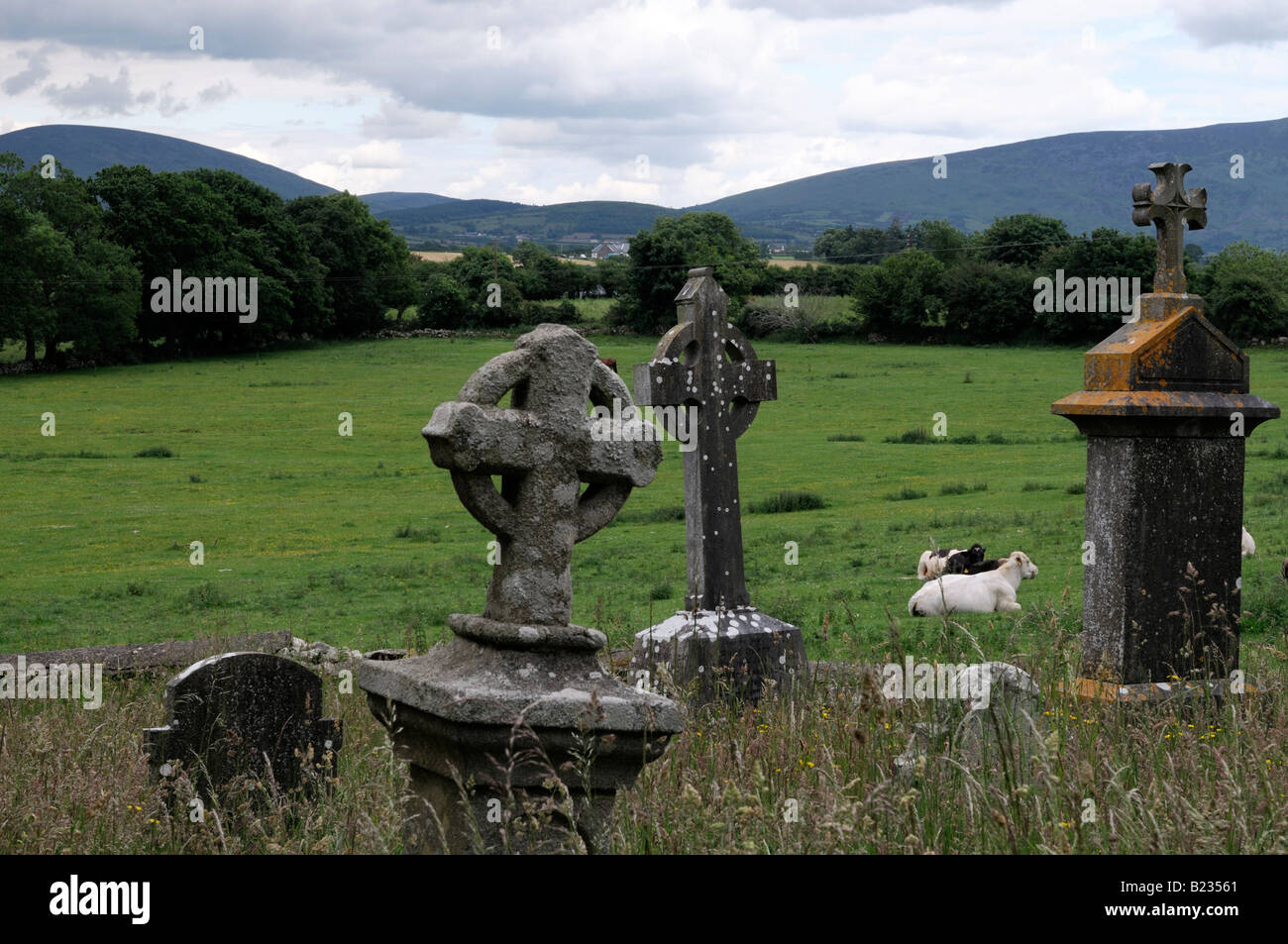 stone cross in graveyard overlooking green grassy field Stock Photo - Alamy